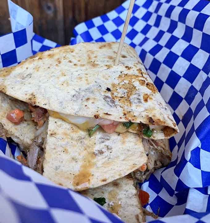 Melted cheese oozes from a perfectly grilled quesadilla, delivering comfort food that pairs beautifully with the throwback atmosphere.