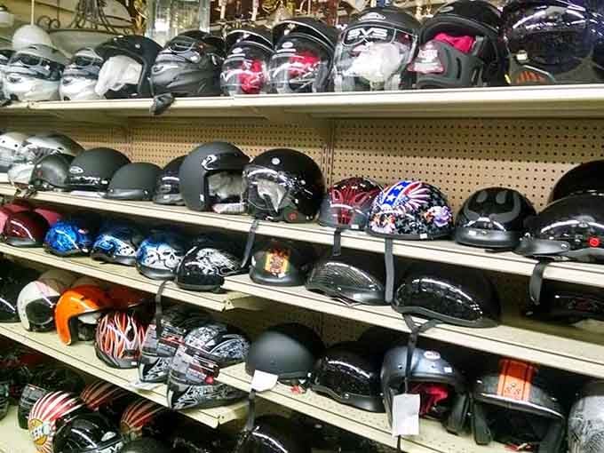 Motorcycle helmets displayed in wild designs, from patriotic stars to flames that scream Easy Rider.