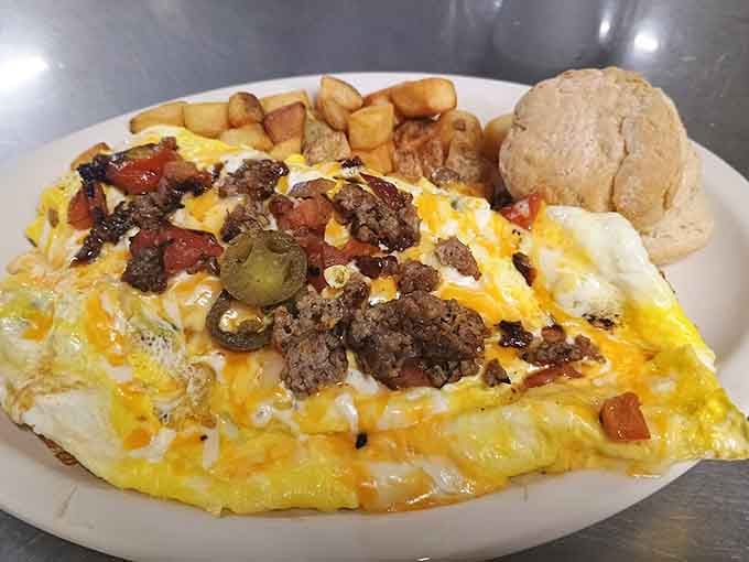 This loaded omelet with breakfast potatoes and a biscuit is how champions start their day in Texas.