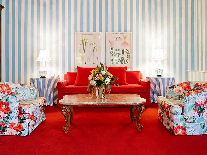 Red carpeting bold enough to make a statement, paired with floral chairs that aren't afraid to show their personality.