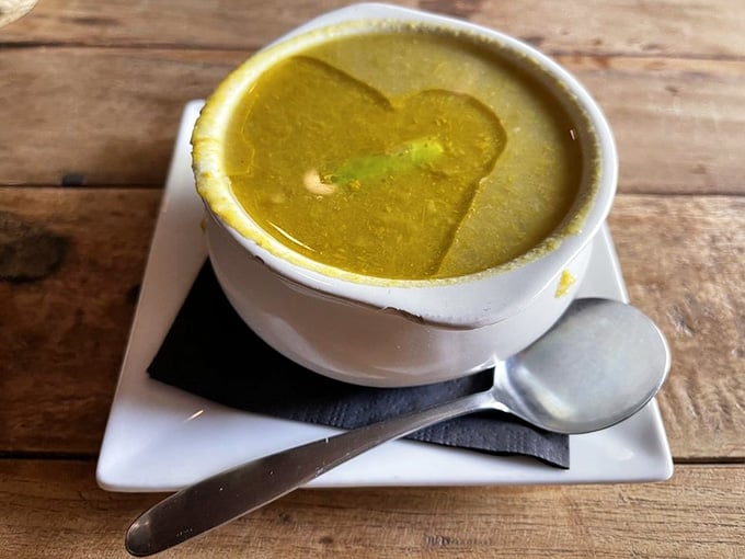 A heart-shaped pat of butter melting into golden soup is comfort food literally wearing its feelings on its sleeve.