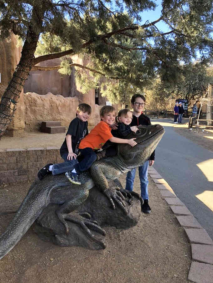 Kids climbing on animal statues: proof that some photo opportunities never go out of style, generation after generation.