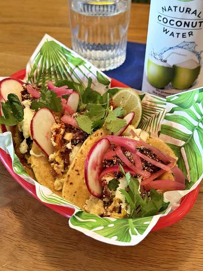 Breakfast tacos served in a palm-leaf basket, because presentation matters even at brunch time always.