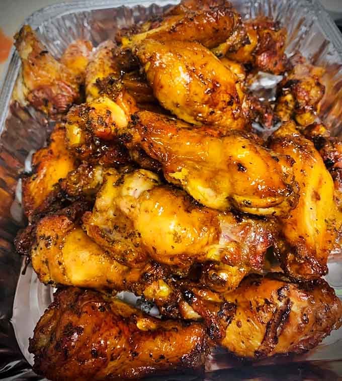 Wings glazed to perfection, glistening like they've been dipped in liquid gold and happiness.