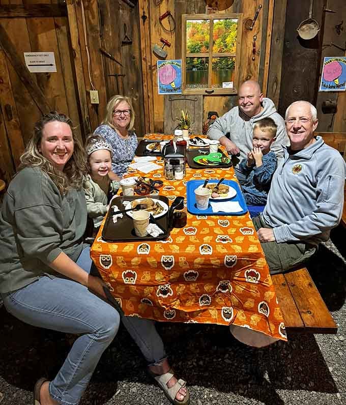 Three generations sharing pancakes in a barn, creating the kind of memories Instagram wishes it could capture.