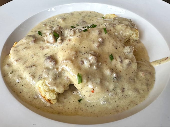 Biscuits drowning in sausage gravy like they're auditioning for a Southern comfort food hall of fame and nailing it.