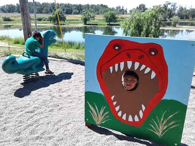 Smile for the camera and pretend you're not absolutely thrilled to stick your head in a T-Rex's mouth.