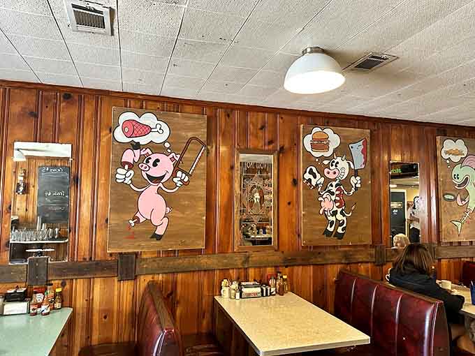 Whimsical cartoon characters on wood-paneled walls create a playful atmosphere that makes every meal feel like a celebration.