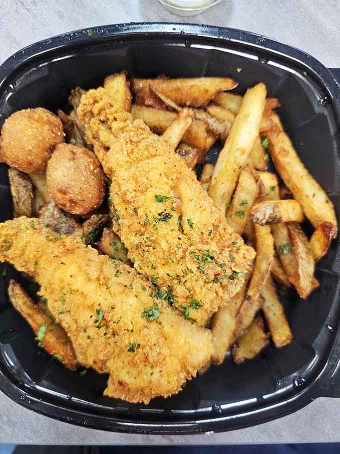 Crispy perch with fries and hush puppies, the complete fish dinner experience in one satisfying plate.