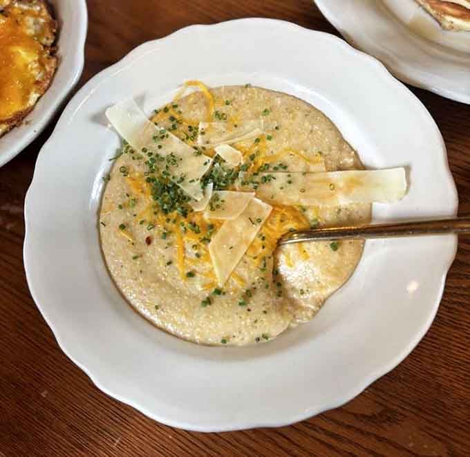 Creamy cheese grits topped with fresh herbs prove Southern comfort food translates beautifully to the Upper Midwest breakfast table.