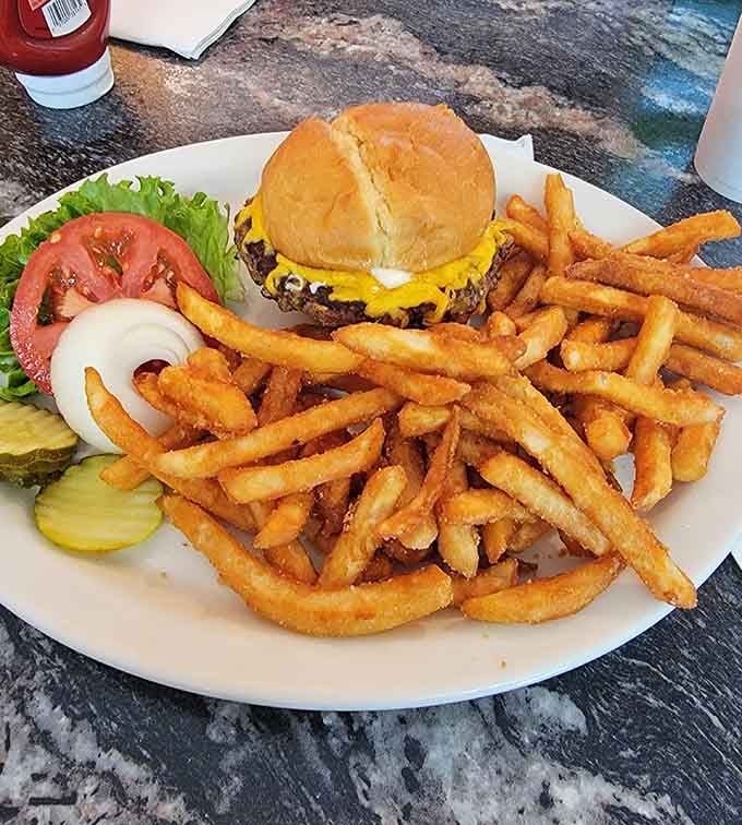 Sometimes lunch calls, and this burger with its mountain of fries answers with enthusiasm and melted cheese.