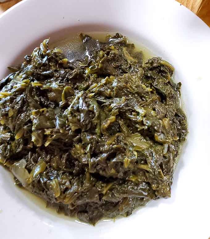 Turnip greens cooked low and slow, turning skeptics into believers one spoonful at a time since forever.