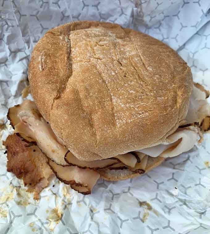 That's a serious turkey sandwich right there, folks&mdash;smoked meat stacked tall enough to require strategic planning.