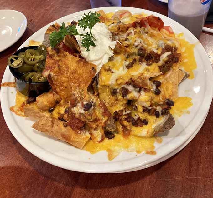 Nachos piled high enough to require an engineering degree to eat without causing a cheese avalanche on your shirt.
