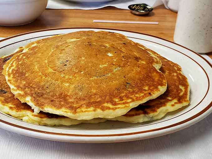 Golden pancakes stacked high and ready to soak up butter and syrup like the breakfast champions they are.