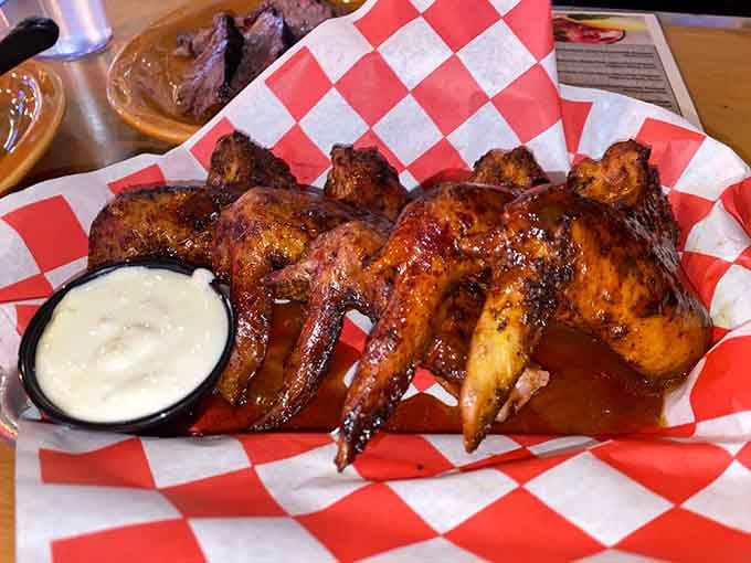 Whole smoked wings glazed to perfection, proving that good things come to those who wait for proper pit smoking.