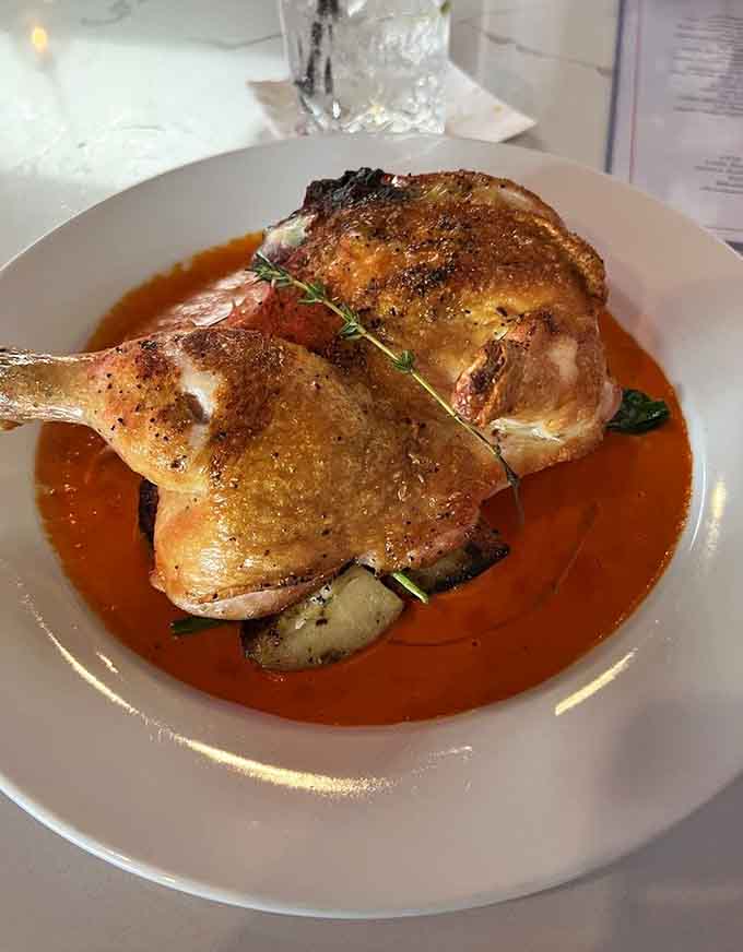 Whole roasted chicken swimming in sauce, the kind of dish that makes you understand why comfort food is universal.