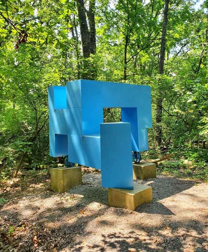 A bright blue geometric sculpture that makes you tilt your head and wonder if gravity still applies here.