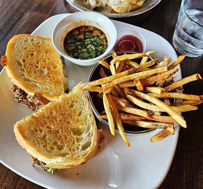 The birria grilled cheese with a side of greens and fries&mdash;because even indulgence needs a vegetable alibi sometimes, right?