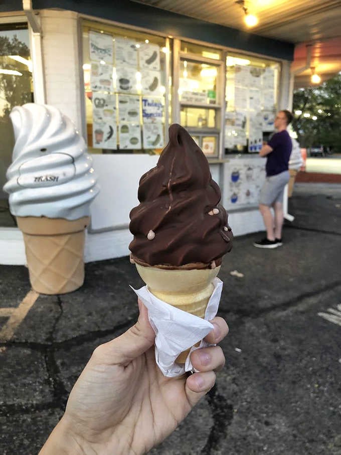 The classic chocolate-dipped cone stands tall against the evening sky, a timeless combination that never goes out of style.