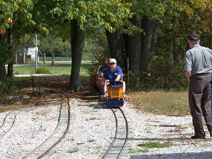 There's something magical about watching a tiny train emerge from the trees, chugging along like it owns the place.