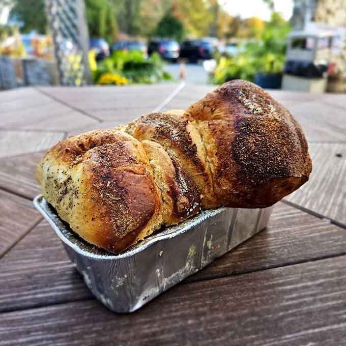 Garlic bread baked in a tin, glistening with butter and herbs, ready to make your taste buds very happy.