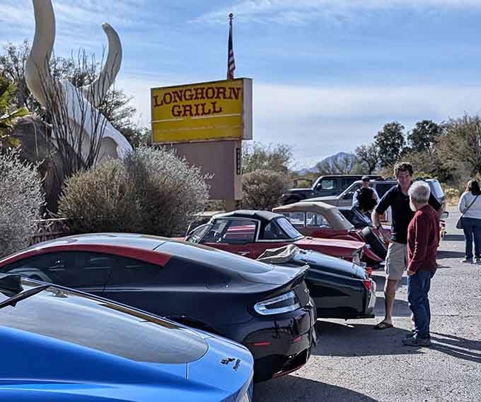 Classic cars gather like pilgrims at this temple of beef, chrome meeting cattle in perfect harmony.