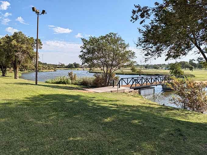 A charming footbridge over peaceful water proves you don't need mountains to find natural beauty.
