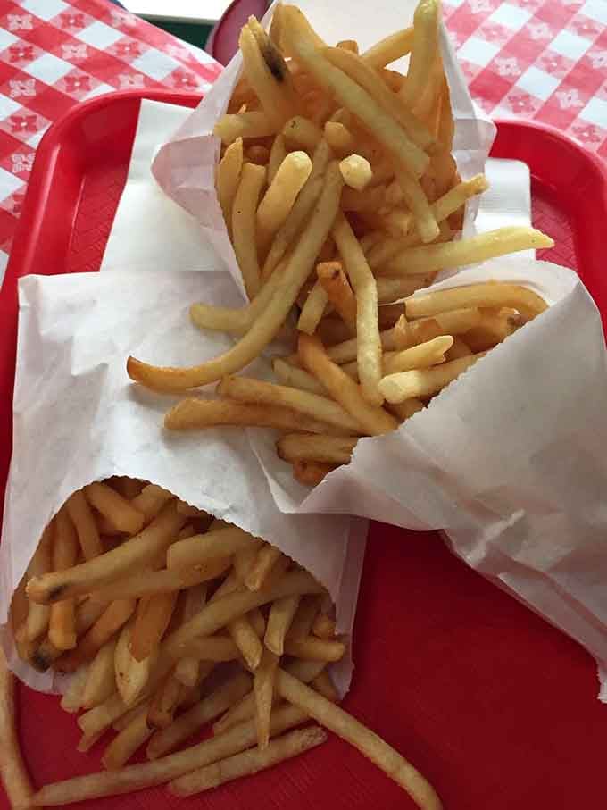 French fries piled high in paper cones, because some traditions are too good to mess with.