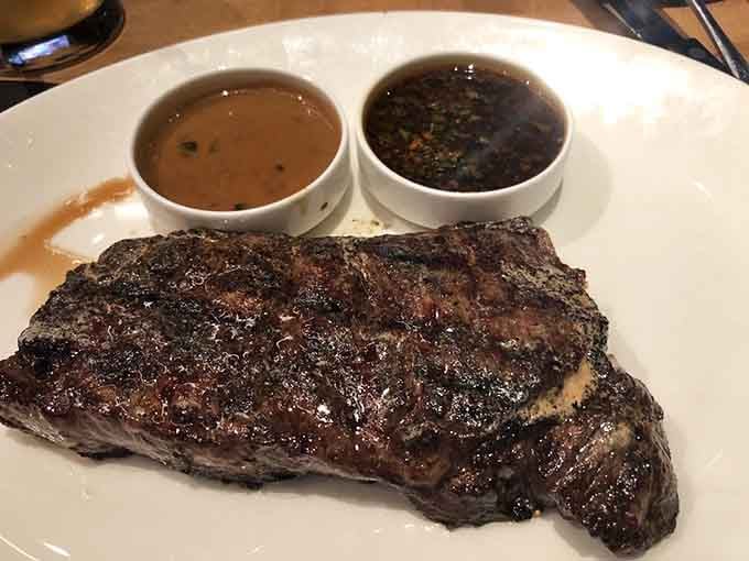 That char on a premium cut of beef, served with dual sauces, proves this sports bar takes steak as seriously as any dedicated steakhouse.