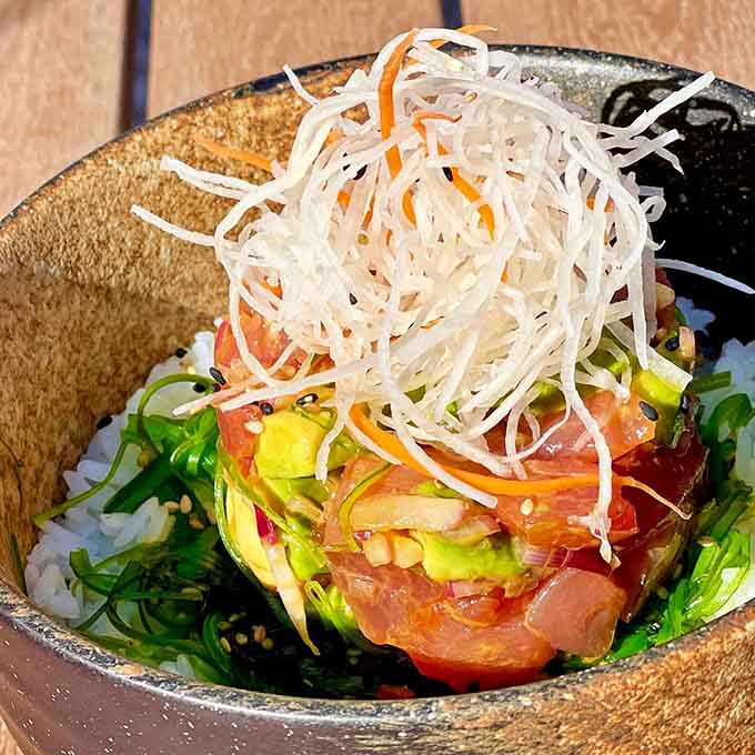 This poke bowl towers like an edible skyscraper of fresh tuna, avocado, and everything your taste buds desire.