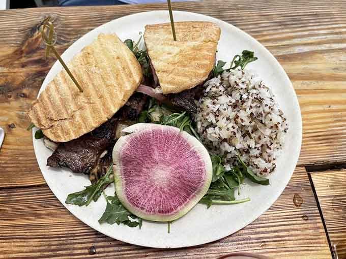 Seared steak meets vibrant watermelon radish on greens, creating a plate as beautiful as it tastes.