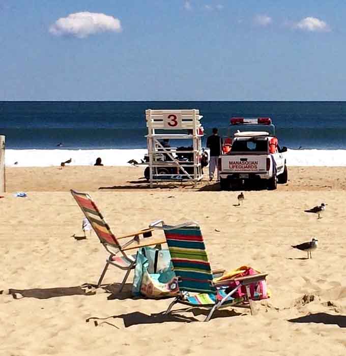 Station three stands ready, where vigilant guardians keep watch and beach chairs claim their sandy territory for the day.