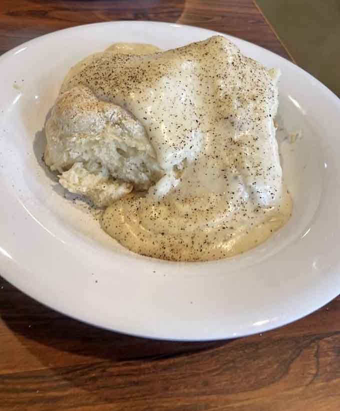 Biscuits smothered in gravy so generously you can barely see what's underneath, which is exactly how it should be.