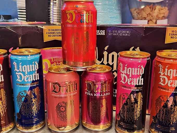 Liquid Death cans stacked like heavy metal album covers, because even hydration deserves to look rebelliously cool these days.