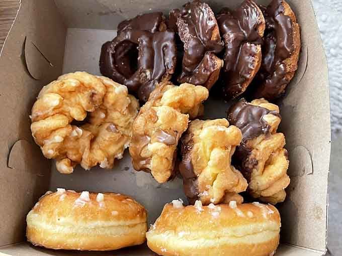 Chocolate-covered crullers and cream-filled rounds arranged like edible treasures that actually deliver on their golden promise.