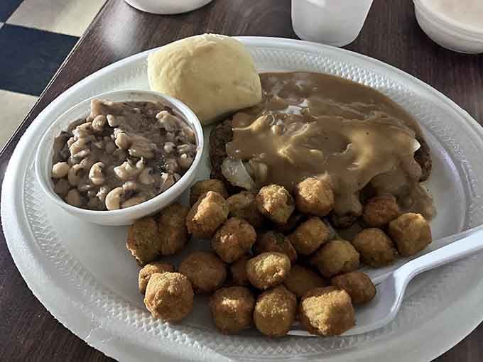 Hamburger steak swimming in brown gravy with all the sides&mdash;this plate understands what comfort food really means.