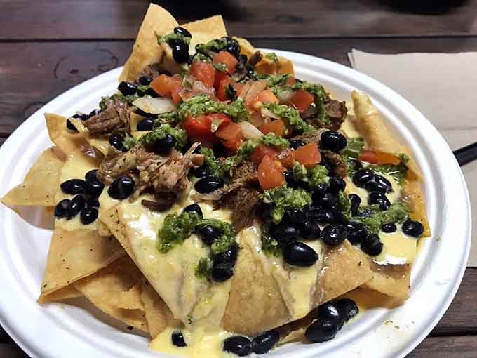 Nachos loaded with pulled pork and all the fixings, because sometimes you need your meal to be a full-contact sport.