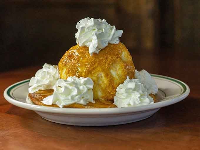 Fried ice cream defies physics and common sense, delivering hot-meets-cold magic crowned with billowy whipped cream clouds.