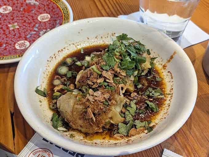 Those glistening chili oil dumplings swimming in spicy sauce are basically edible happiness in a bowl.
