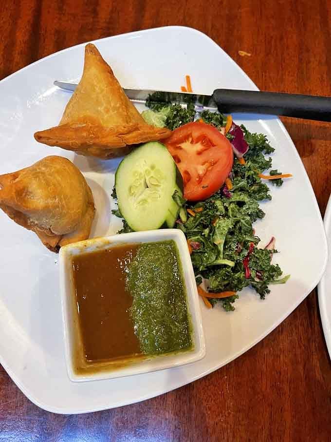 Vegetable samosas arrive golden and crispy, those triangular pockets of joy that disappear faster than your willpower at this buffet.