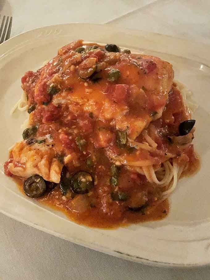 Halibut puttanesca bringing Mediterranean flair to your plate like Sophia Loren crashing your dinner party.