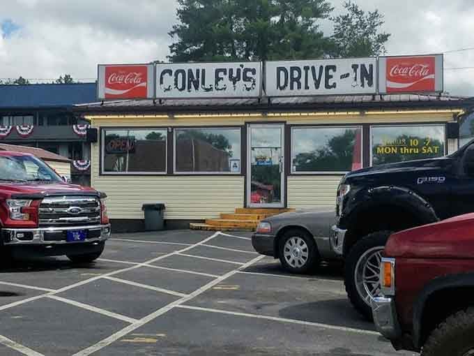 Vintage Coca-Cola signs crown this classic drive-in where burgers taste better eaten in your car under open skies.