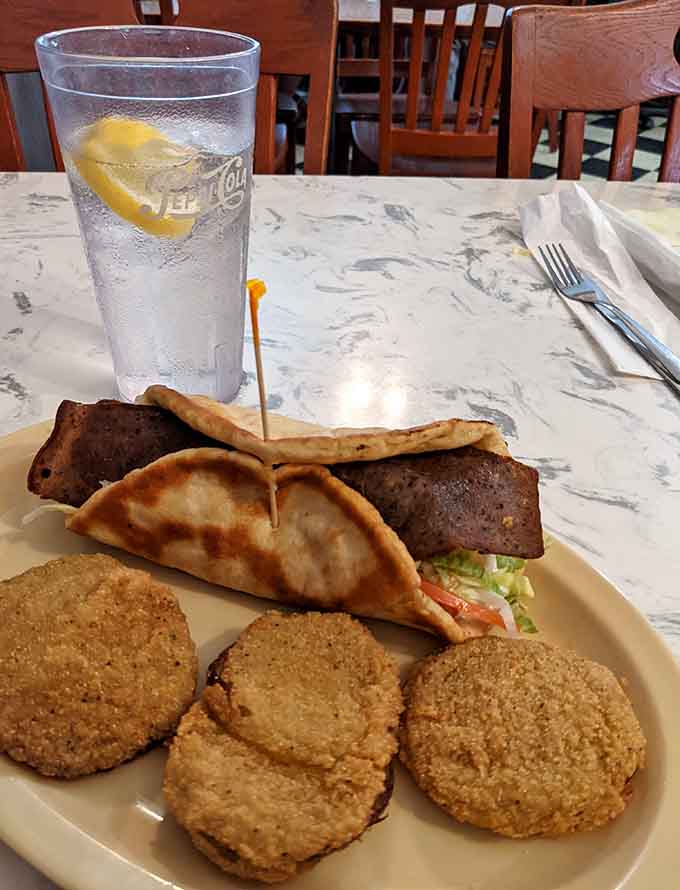 Fried green tomatoes paired with perfectly seasoned patties make this plate sing with Southern soul and flavor.