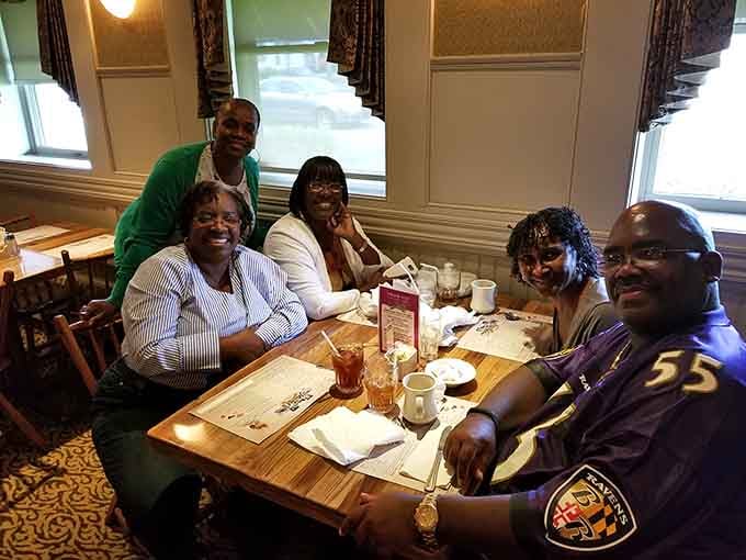 Happy diners gathered around the table, proof that good food brings people together every time.