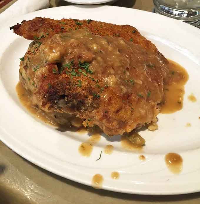 Baked pork chops smothered in savory dressing and gravy make you understand why comfort food got its name.