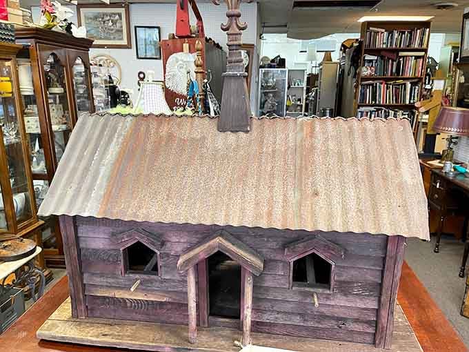 This weathered miniature building looks like it escaped from someone's elaborate model train setup decades ago.