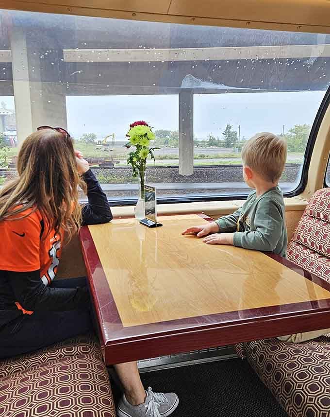 Young travelers mesmerized by passing scenery prove that train windows beat tablets for entertainment every single time.