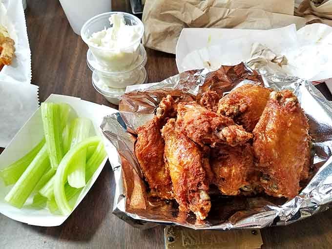 Chicken wings glistening with sauce, served with celery sticks that are technically vegetables so everything balances out nutritionally, right?