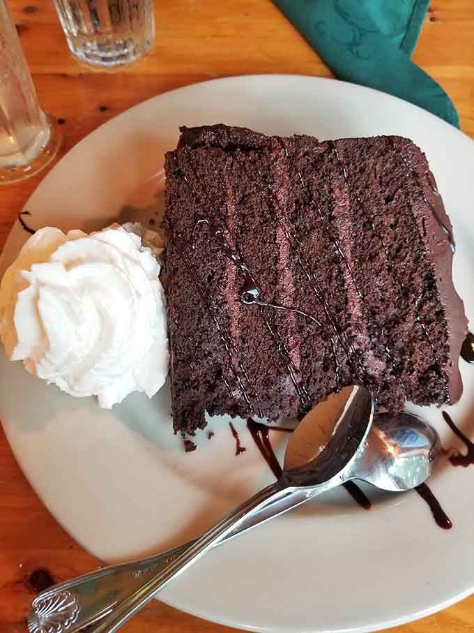 That towering chocolate cake with whipped cream is the kind of dessert that makes you loosen your belt without regret.